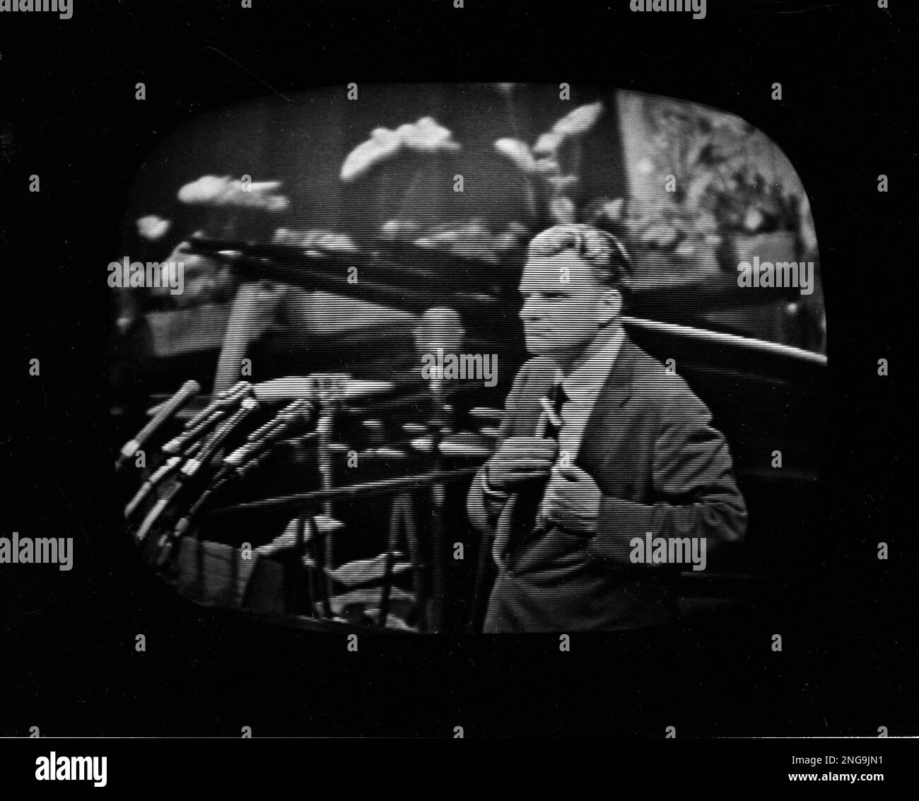 The Rev. Billy Graham appears on a television screen during a live ...