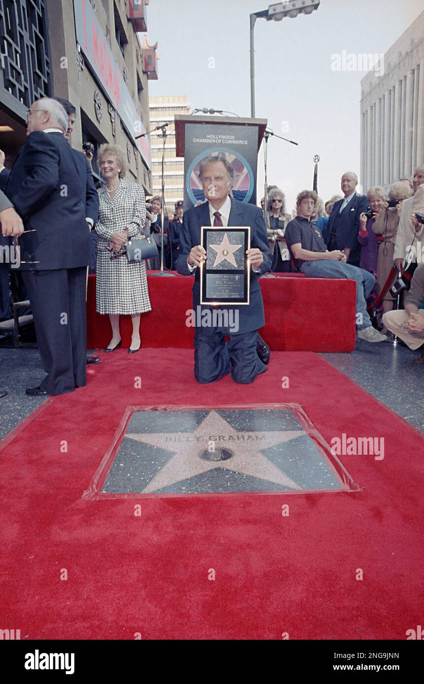 Televangelist Billy Graham poses next to his star on the Hollywood Walk ...