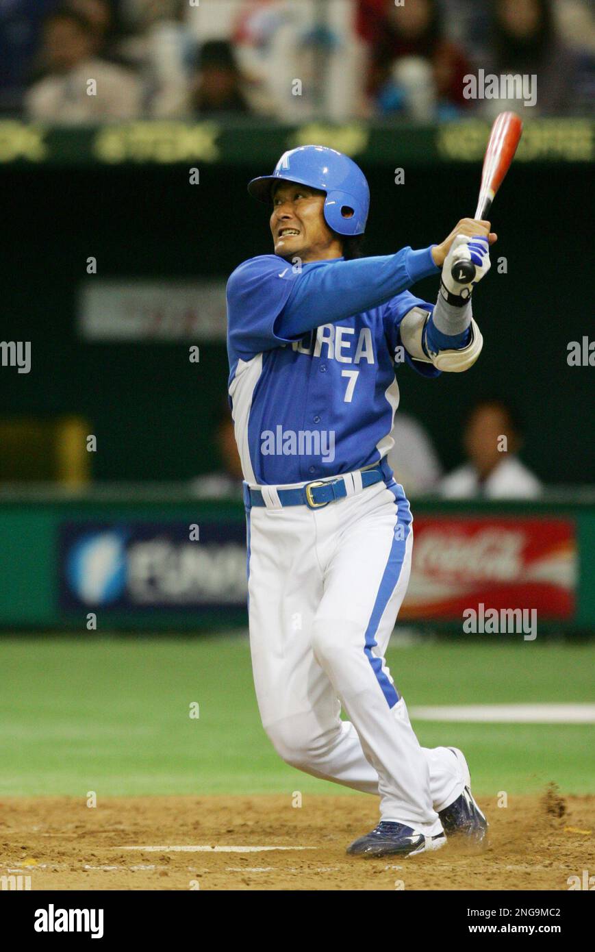 South Korea's Lee Jong-Beom watches the flight of his an RBI double off ...