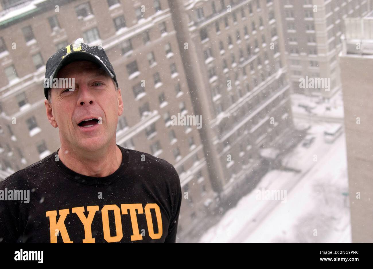 Actor Bruce Willis poses in the snow on a terrace at the Regency Hotel ...