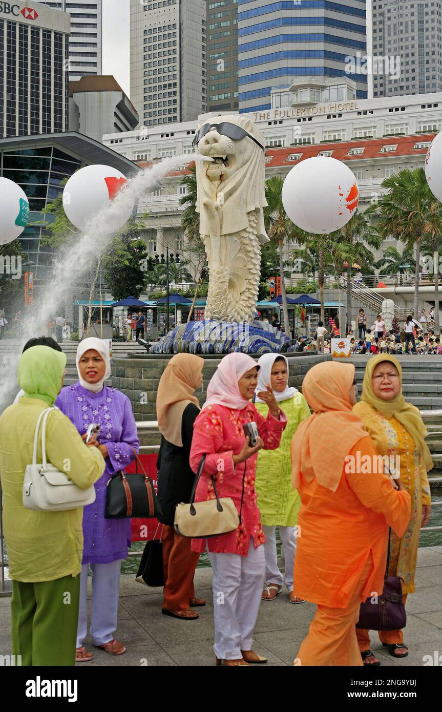 Muslim women gather in front of Singapore's icon, the Merlion which was ...