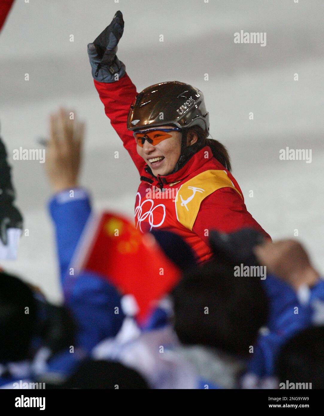 China's Xinxin Guo waves to the crowd after her first of two jumps in ...