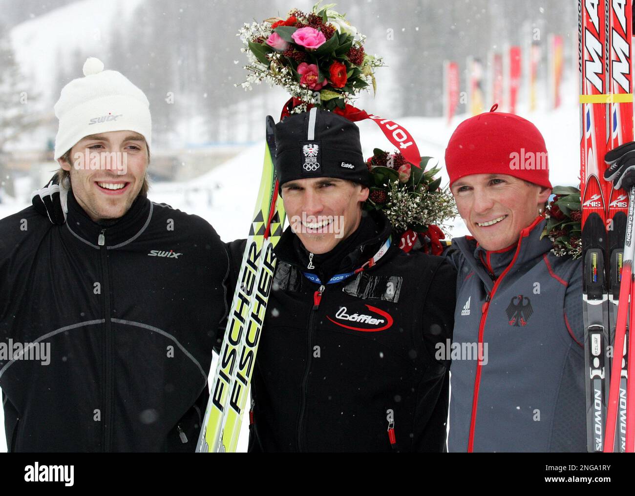 Austria's Felix Gottwald, center, celebrates on the podium after ...