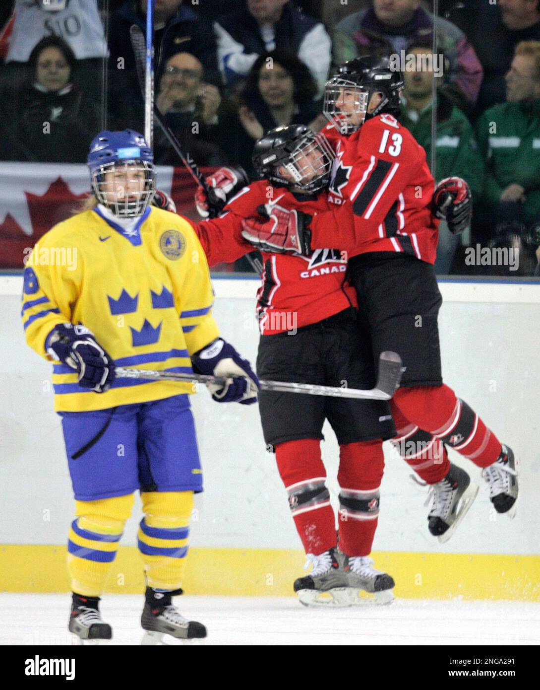 Team Canada's Caroline Ouellette (13) celebrates with teammate Jennifer ...
