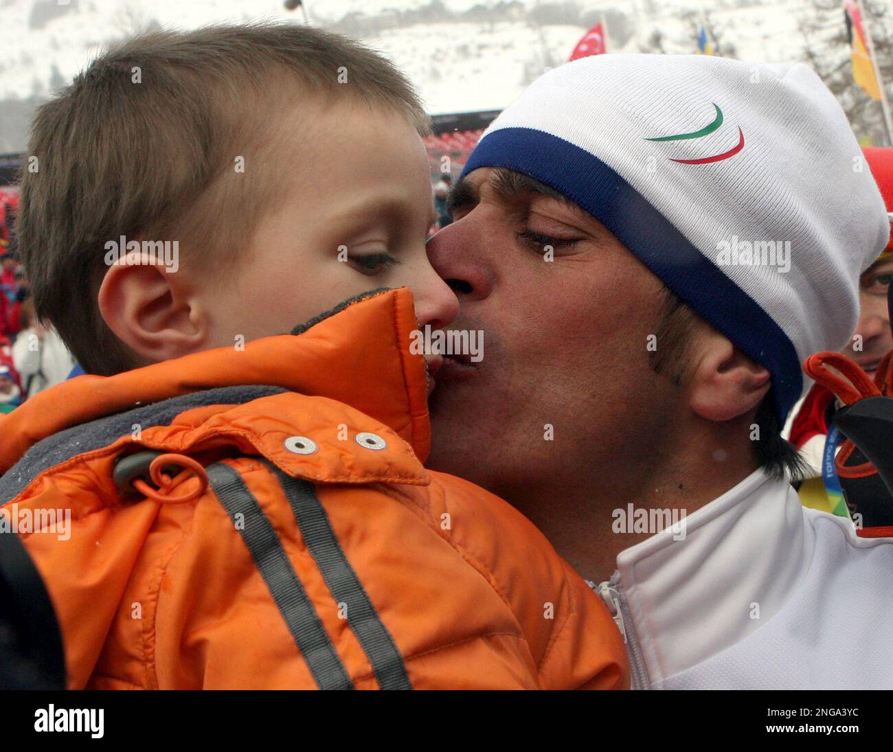 Italy's Pietro Piller Cottrer, right, kisses his son Fabio after ...