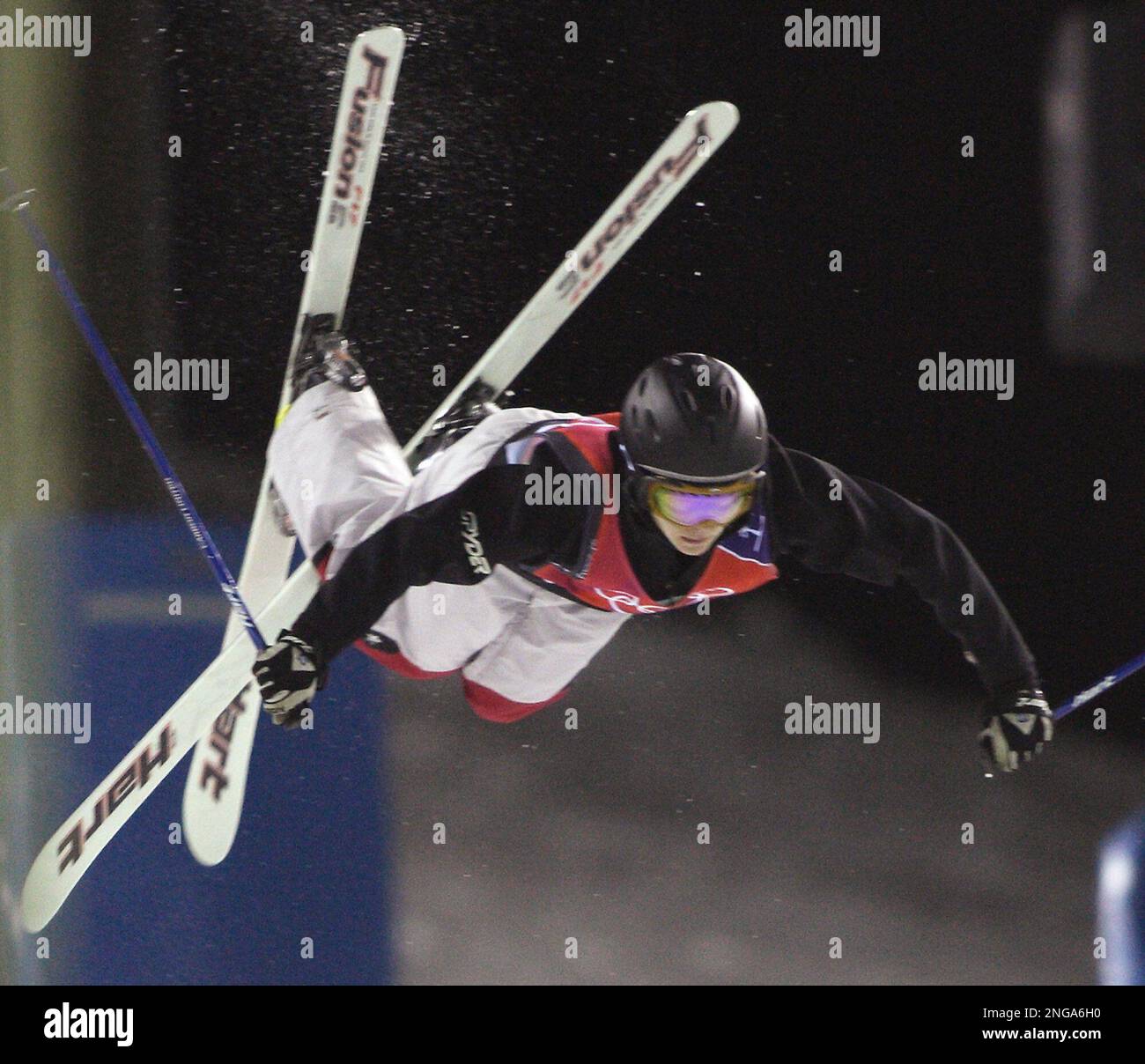 Jennifer Heil of Spruce Grove, Alta., performs her final jump on her ...