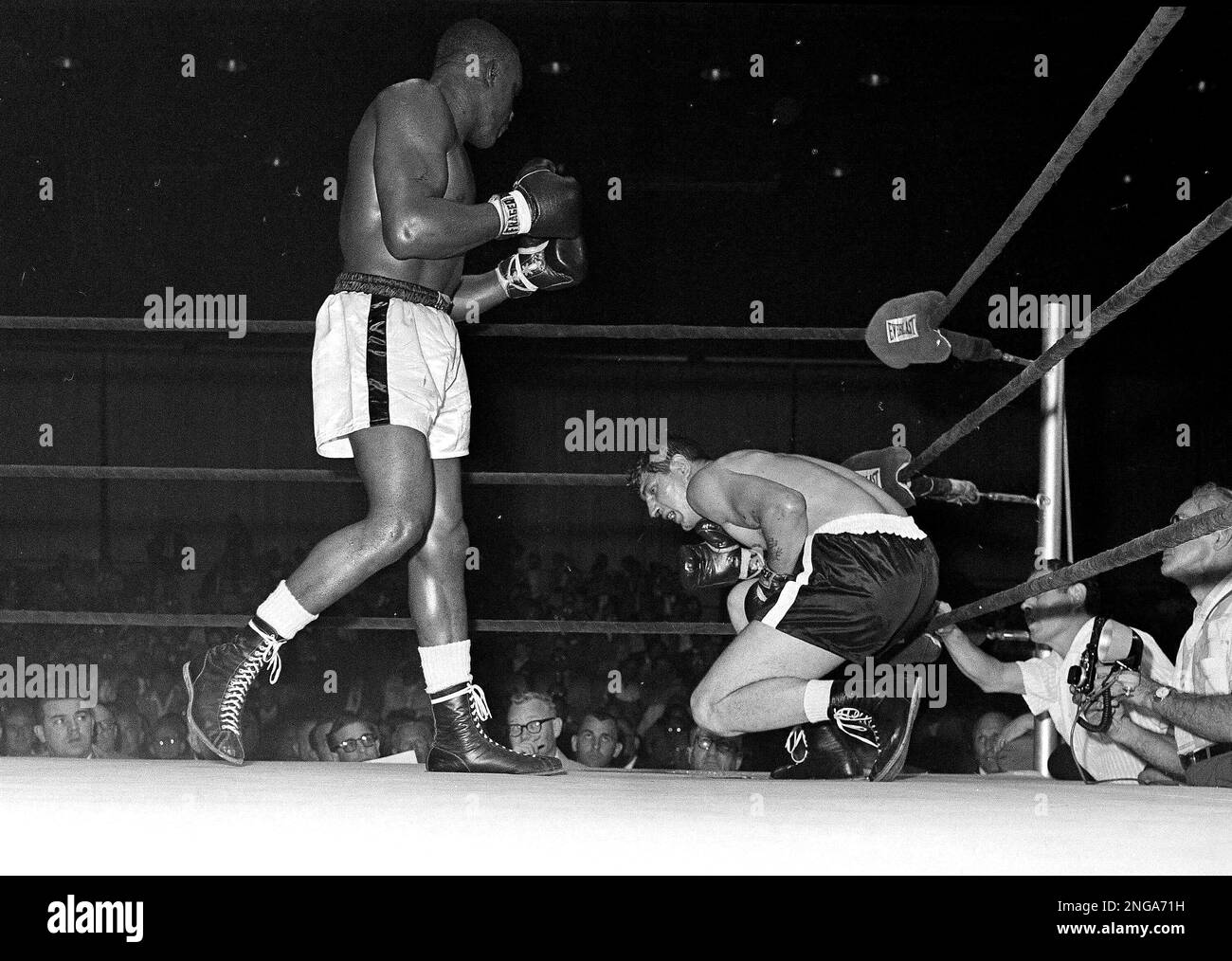 U.S. Charles "Sonny" Liston, left, stands over a battered U.S. Mike ...