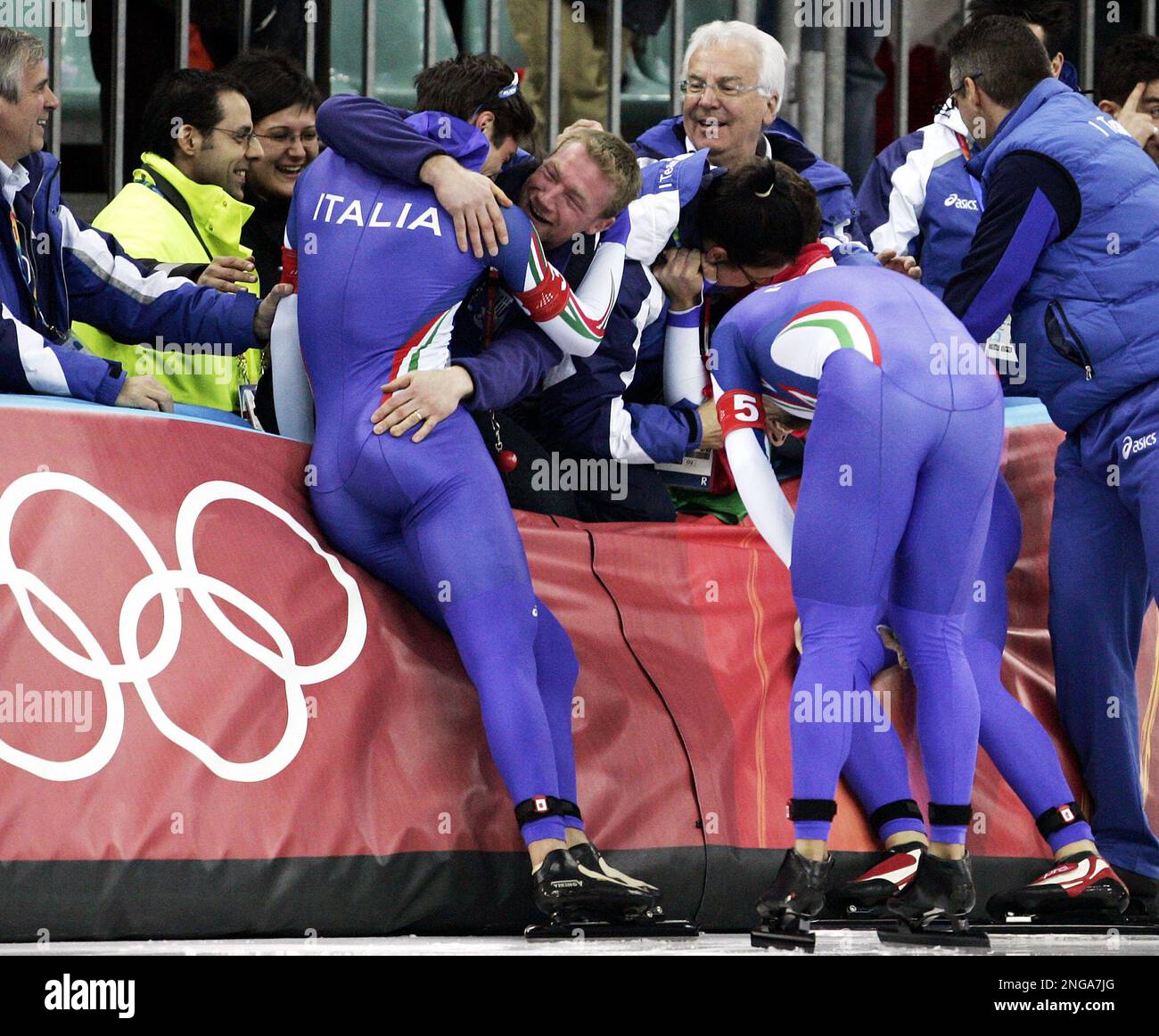 Italian team members celebrate their gold medal victory with coaches ...