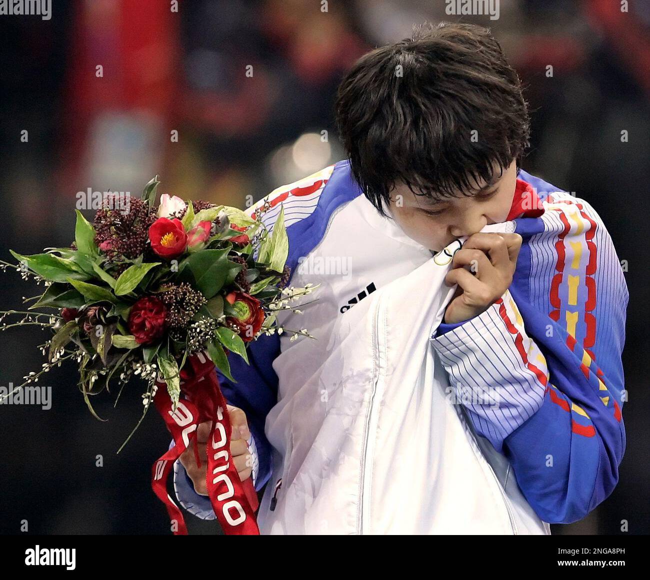 China's Wang Meng kisses the Olympic rings on her team uniform after ...