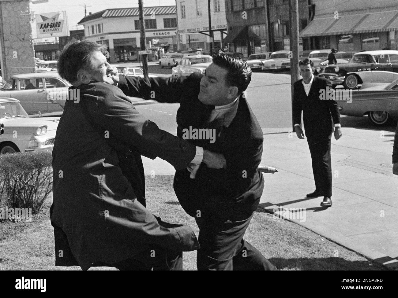 Alton Wayne Roberts, right punches CBS cameraman Laurens Pierce outside ...