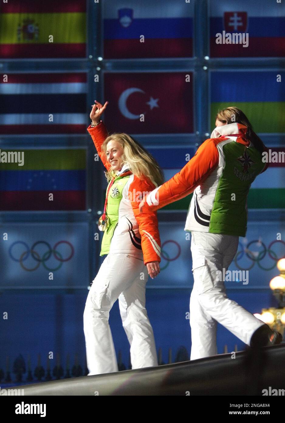 Germany's gold medalist Sylke Otto, left, waves as she walks across the ...