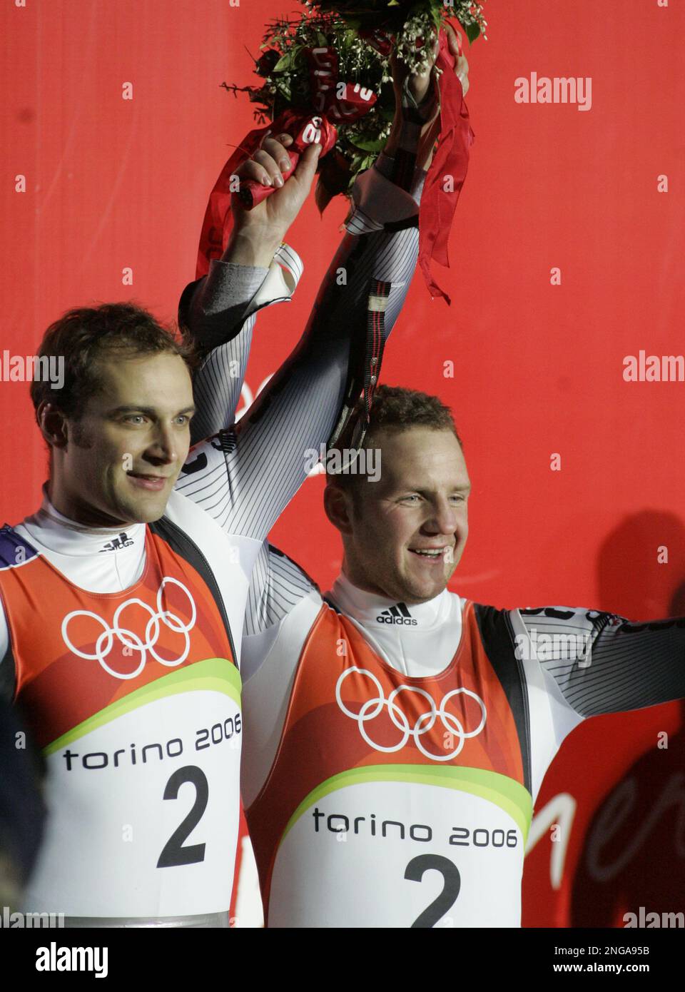 German silver medal sliders Andre Florschuetz, left, and Torsten Wustlich celebrate their win in ...