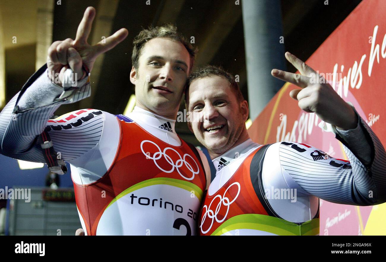 German silver medalist sliders Andre Florschuetz, left, and Torsten Wustlich, right, celebrate ...