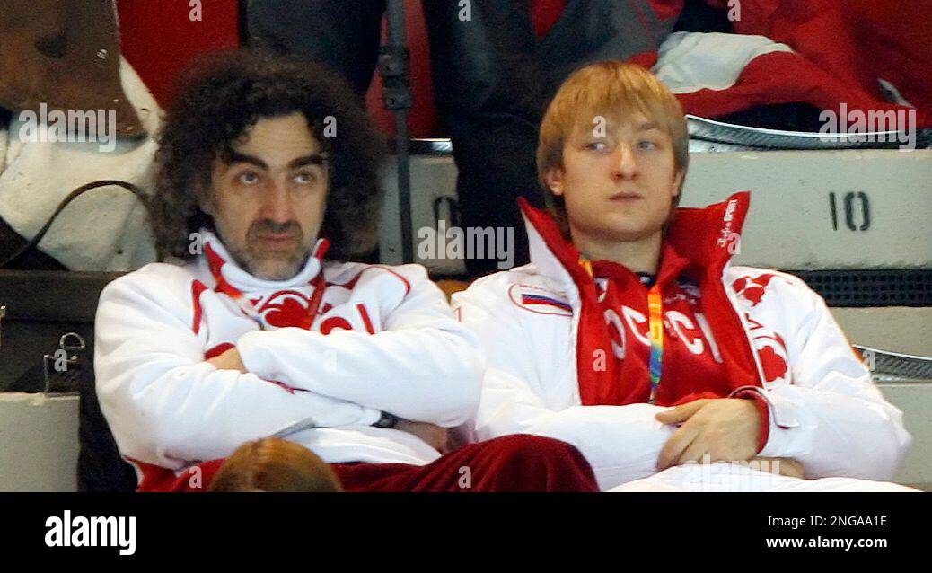 Evgeni Plushenko, of Russia,right and his coach Alexei Mishin watch ...