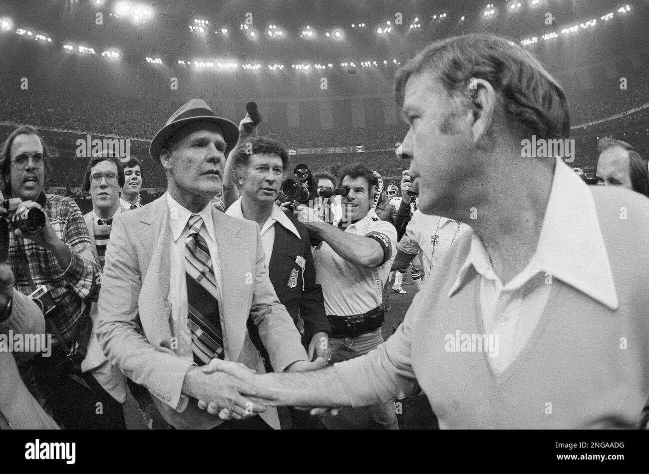 Dallas Head coach Tom Landry, left, accepts congratulations from Denver ...