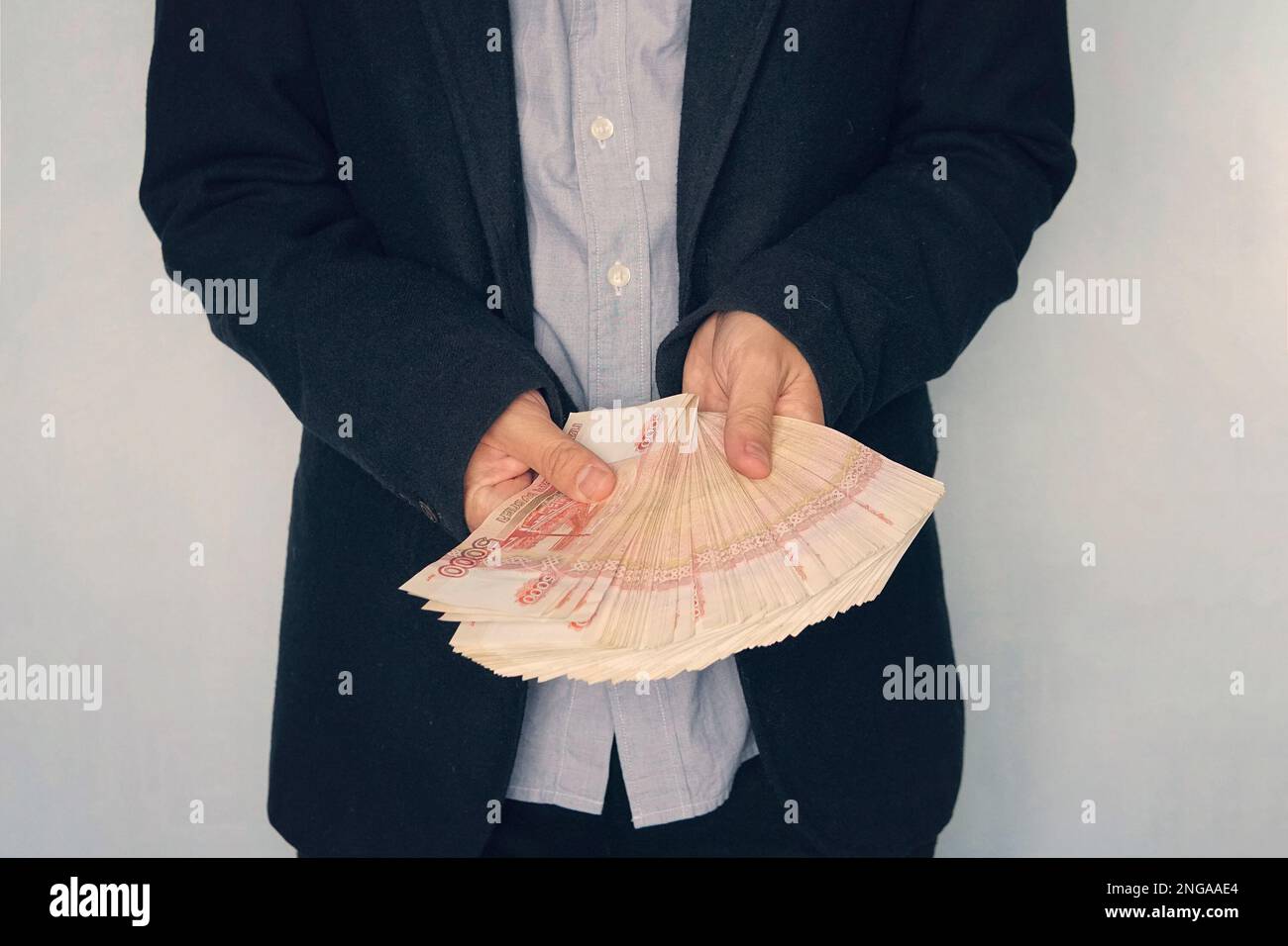 Russian banknotes rubles in hand. businessman thinks of profit. Money ...