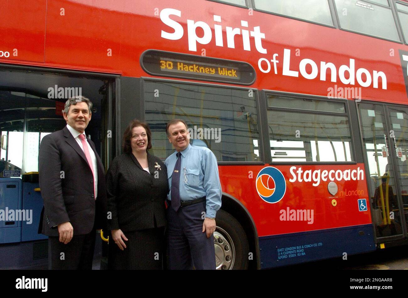 (L-r) Britain's Chancellor Gordon Brown stands in front of a No 30 bus ...