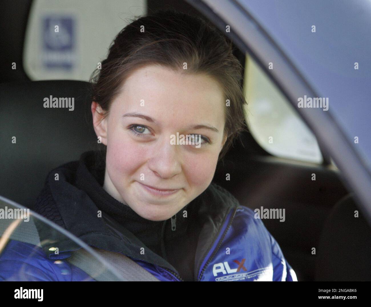 Figure skater Emily Hughes smiles from a car as she leaves a rink where ...