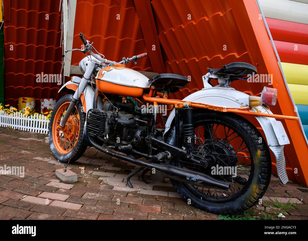 An old retro motorcycle painted in orange-white-black tones Stock Photo ...