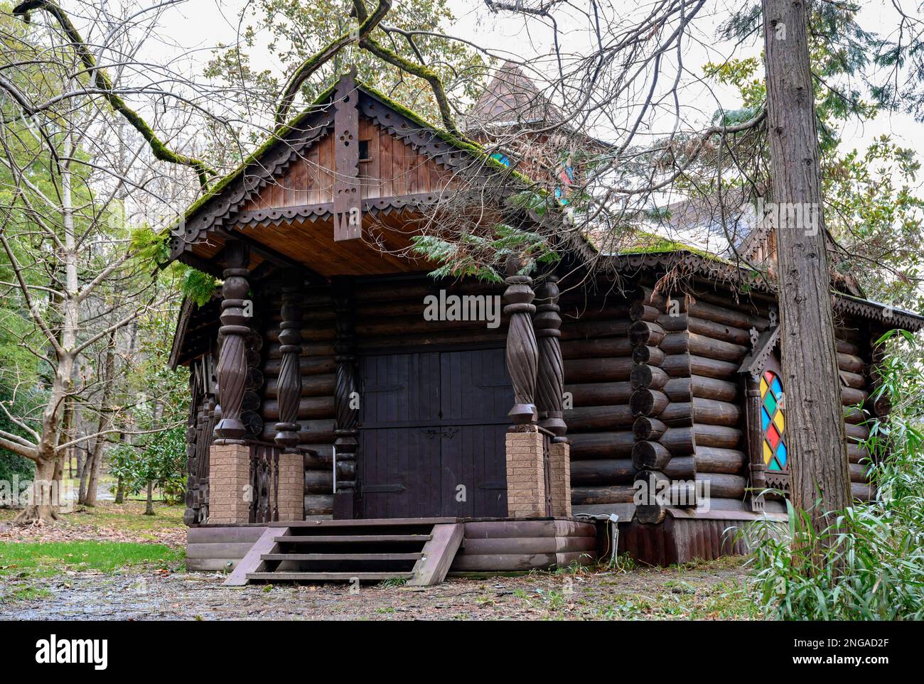 Wooden house with carved columns and platbands in the forest Stock ...
