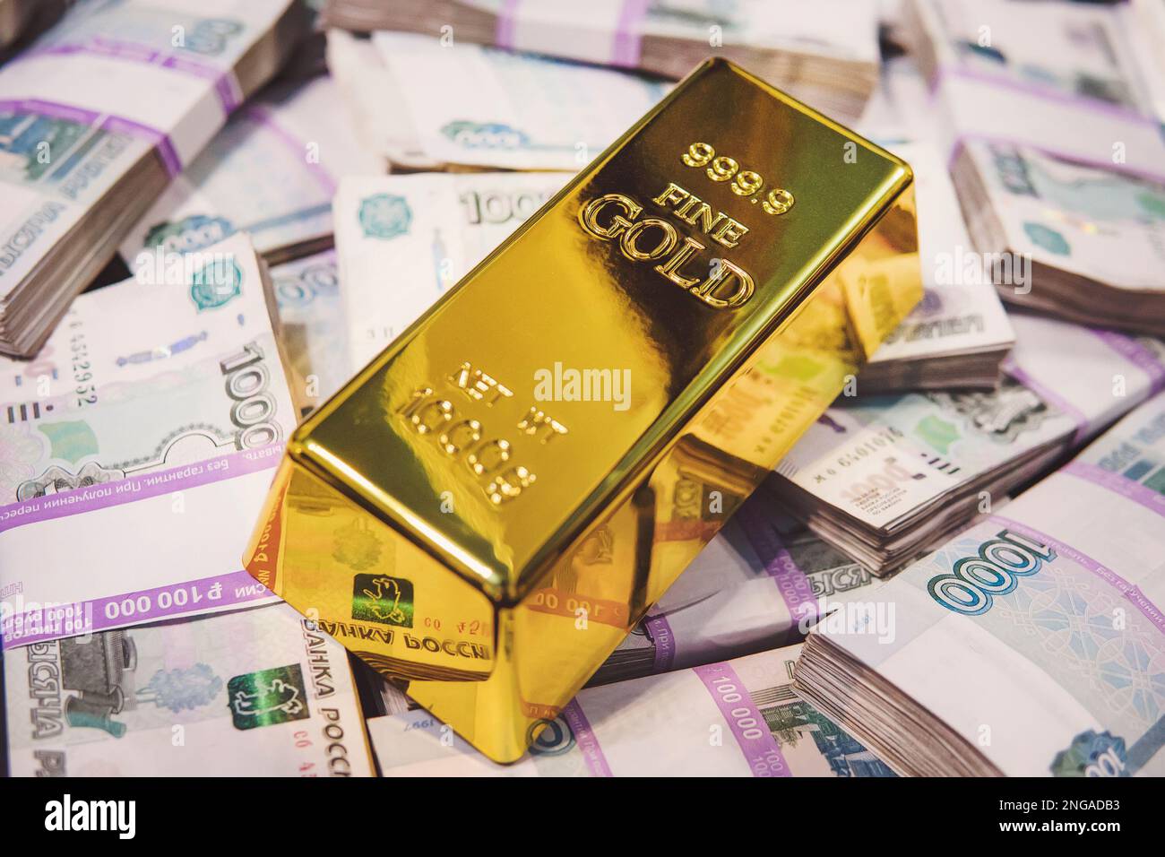 gold bar on russian money background with 1000 rubles banknotes. gold ...