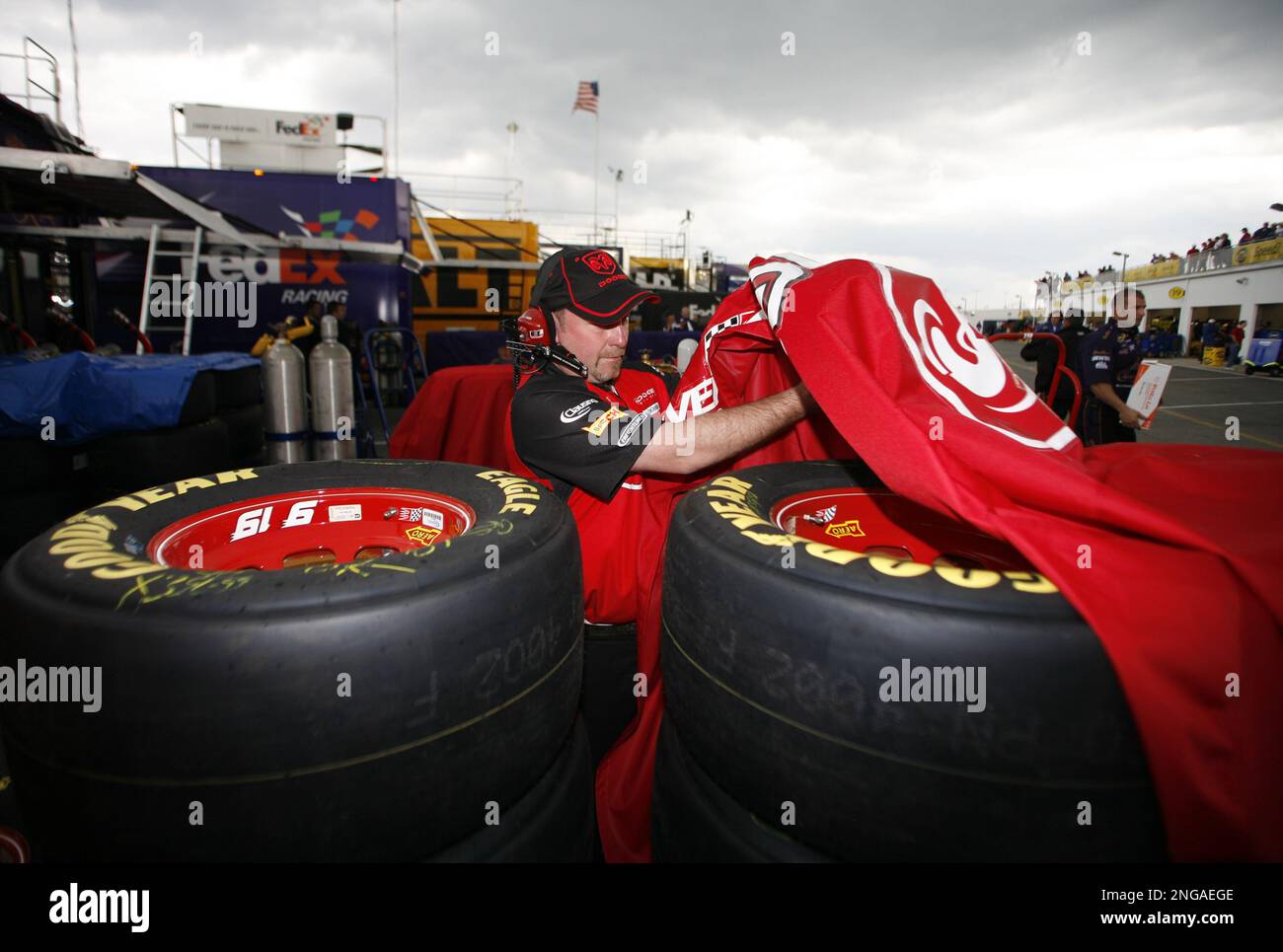 Scott Swift covers tires used for a car driven by NASCAR racer Jeremy ...