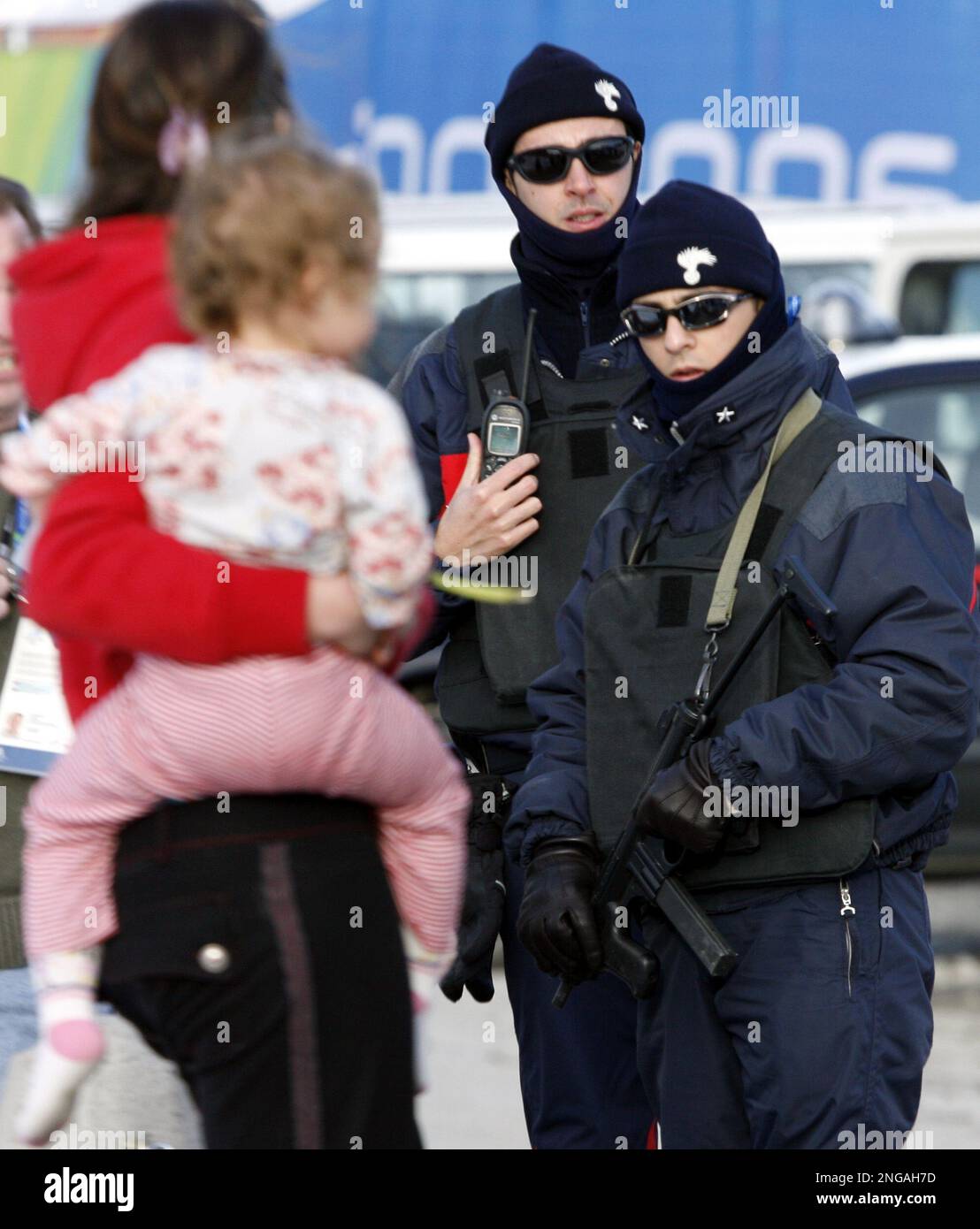 A woman holding a baby asks directions of two Carabinieri (Italian ...