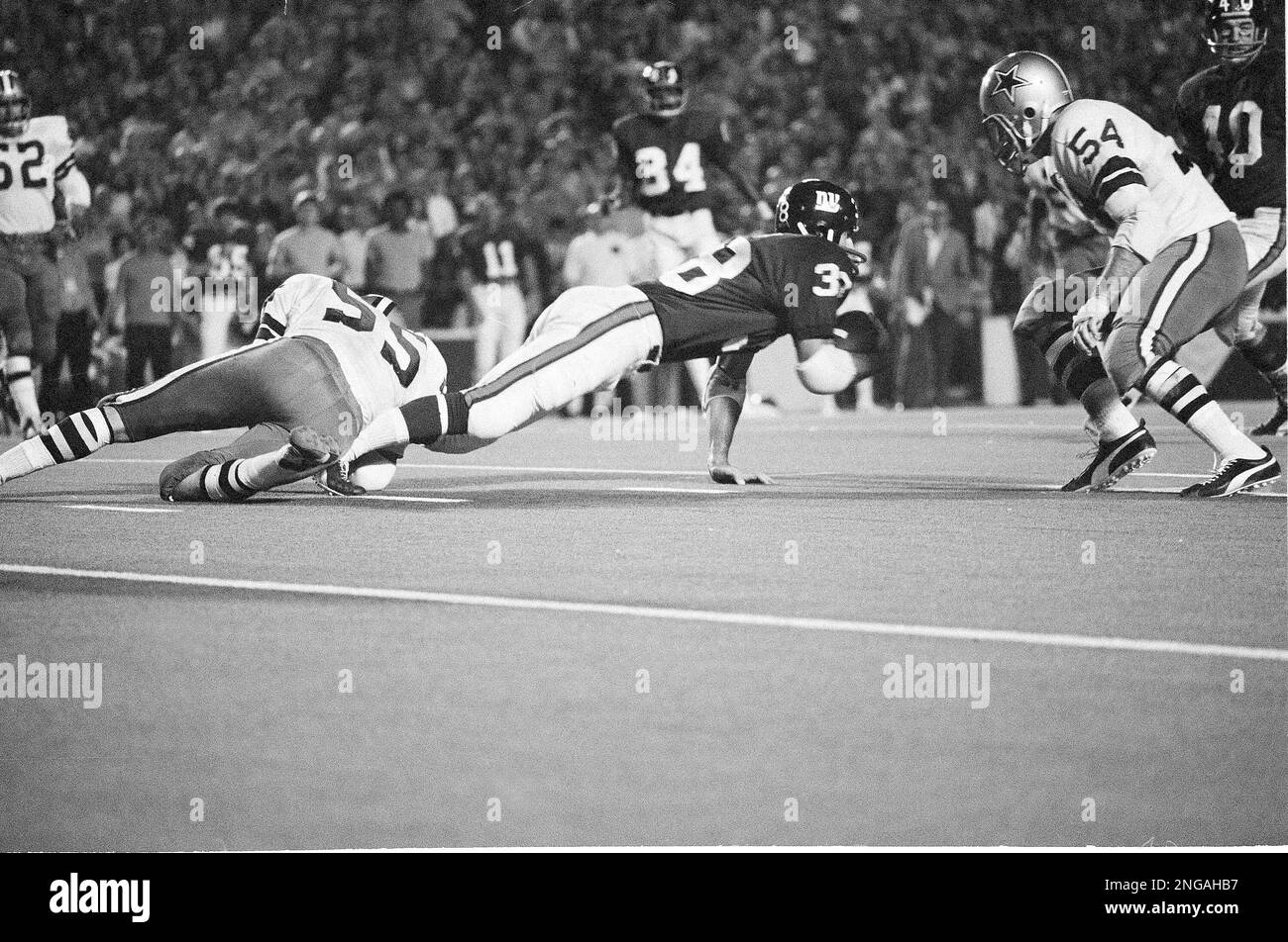 New York Giants tight end Bob Tucker, stretches a 4-yard gain while ...