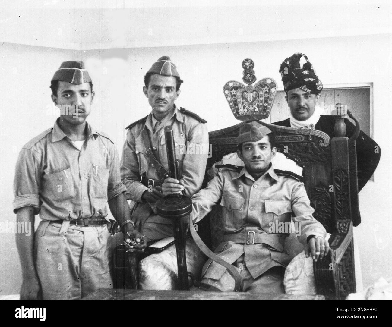 Yemeni army troops sit on the ornate carved throne in the palace of the ...