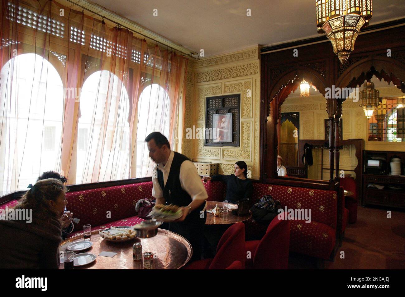 A waiter serves two women at the cafe of the Paris Mosque, Nov. 30 ...