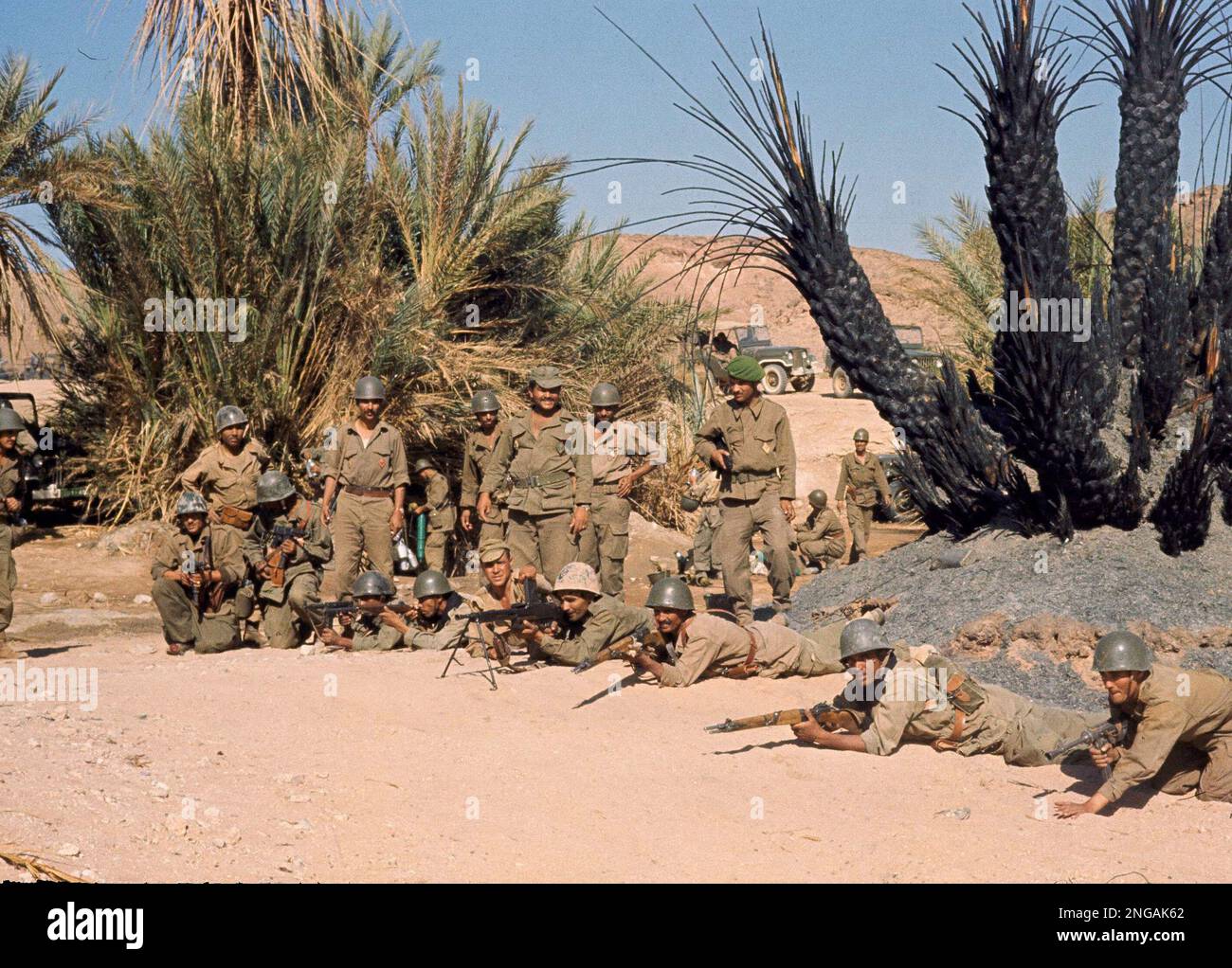 Soldiers take a stance with their guns at the Hassi Beida post in the ...