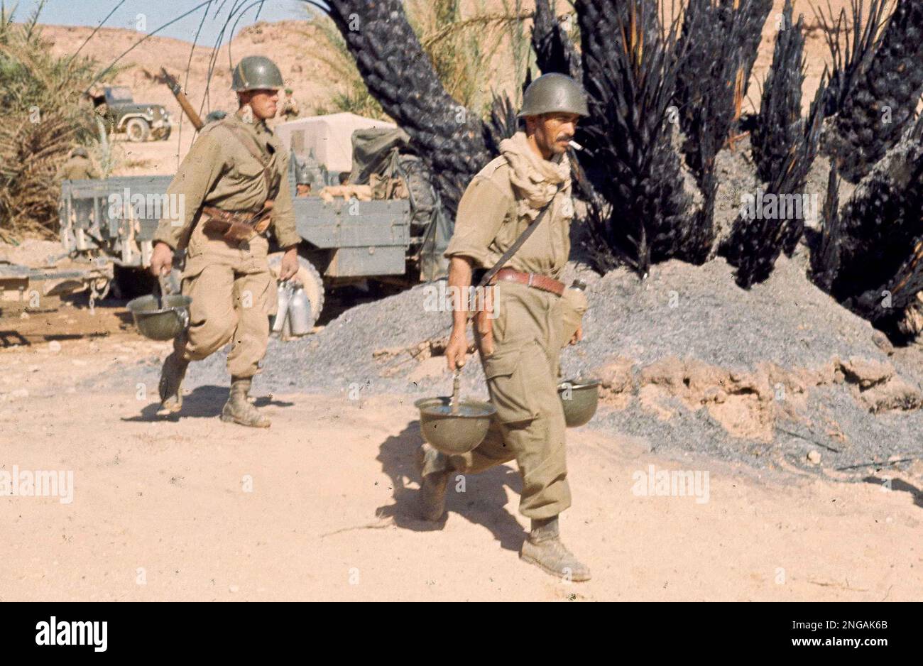 Soldiers carry water in their helmets at the Hassi Beida post in the ...