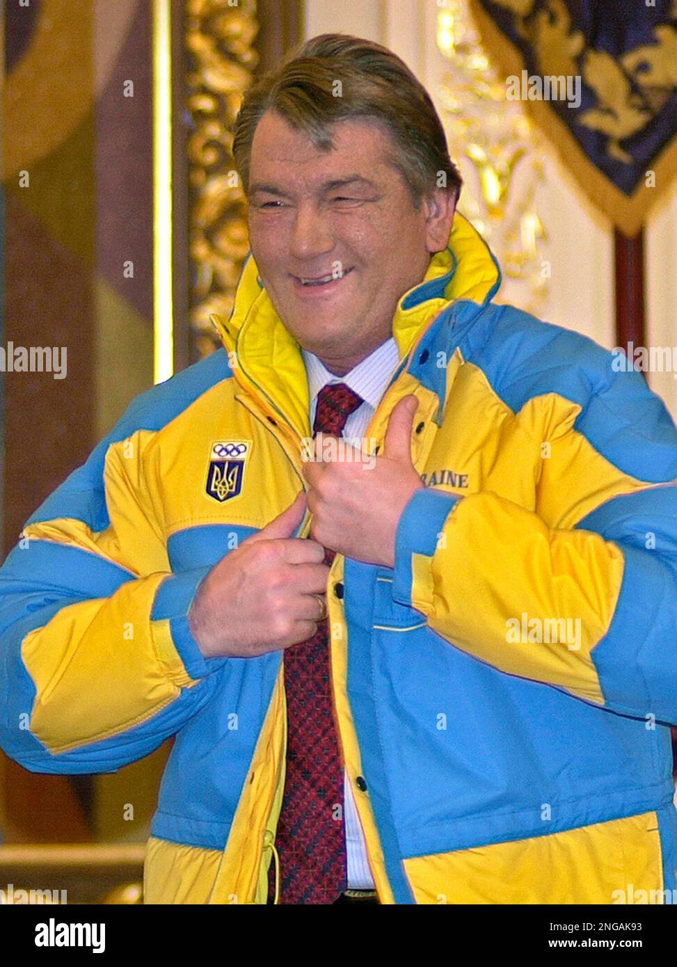 Ukraine's President Viktor Yushchenko smiles as he tries on a Ukrainian ...