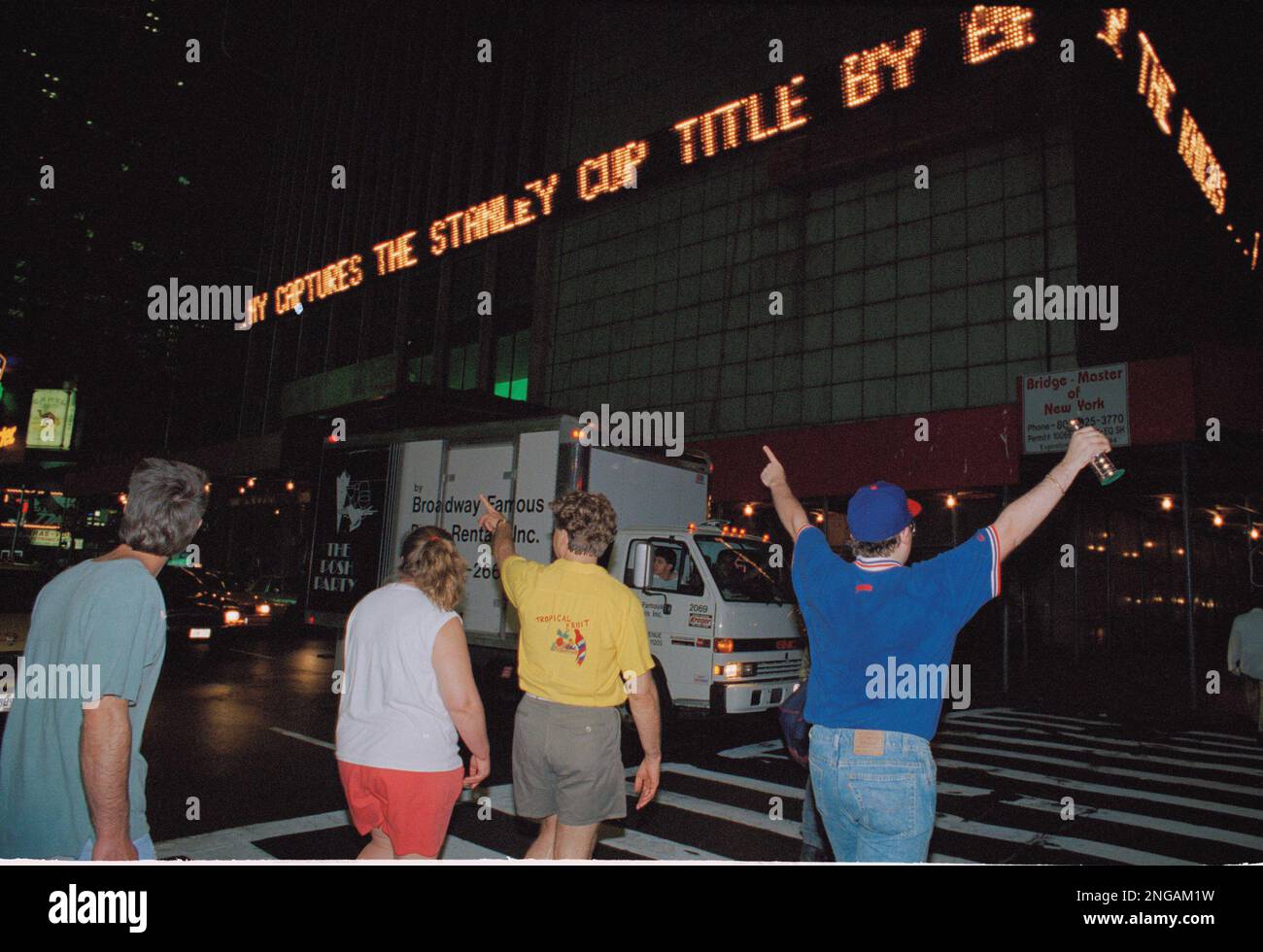 New York Rangers fans celebrate in front of a news zipper in Times ...