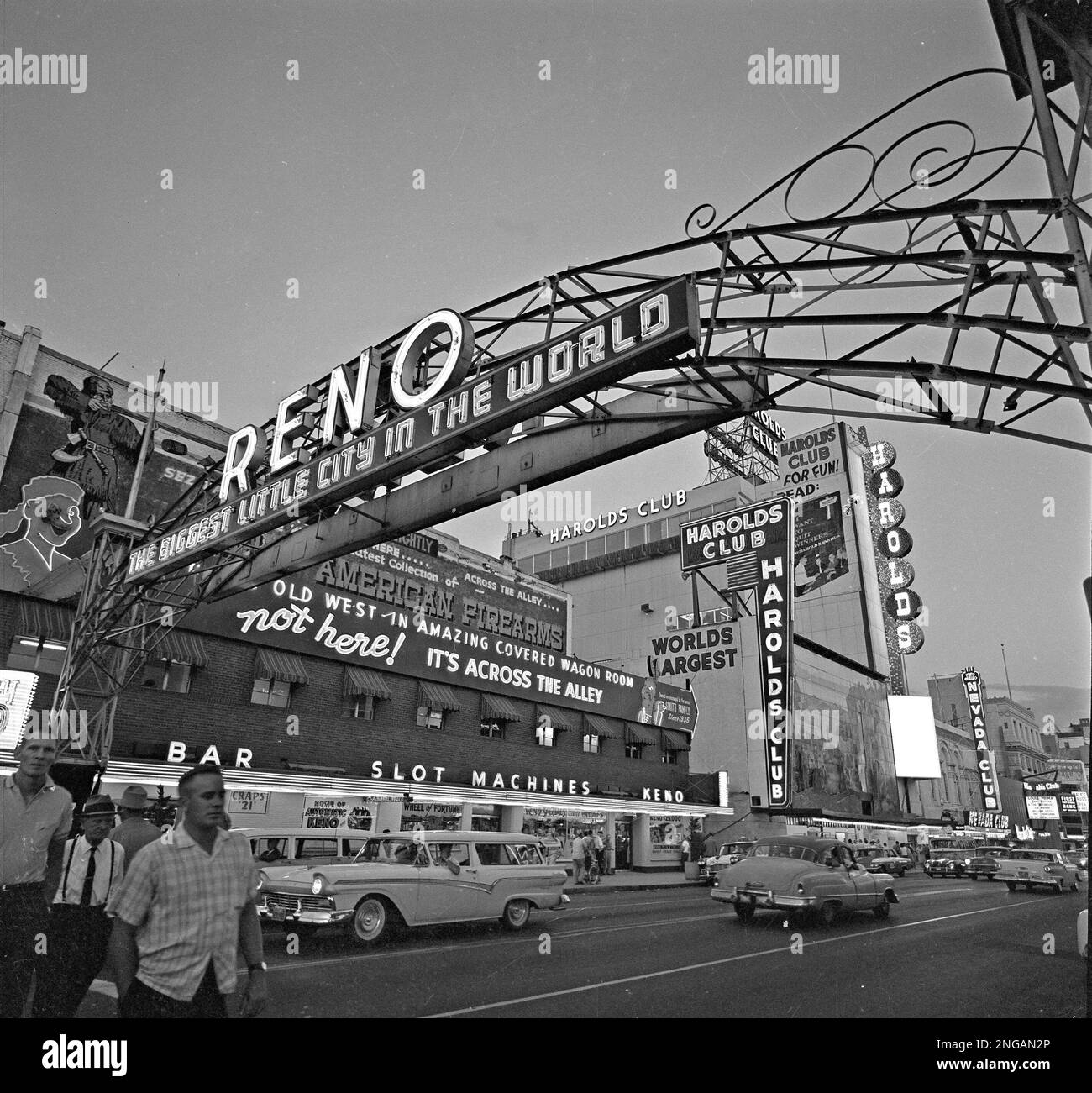 Pedestrians cross Virginia Street as the arch that proclaims "RENO: The ...