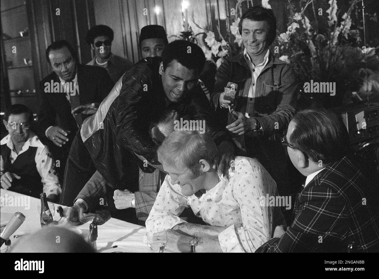 Heavyweight boxer Muhammad Ali pretends to grab his opponent, Britain's ...