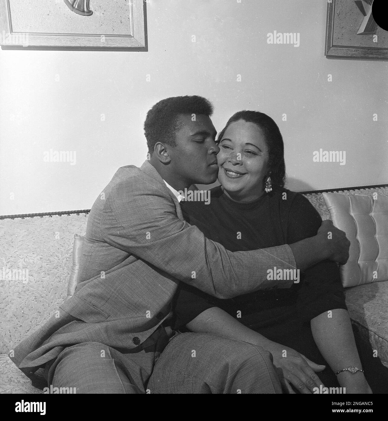 Young heavyweight boxer Cassius Clay plants a kiss on his mother's ...
