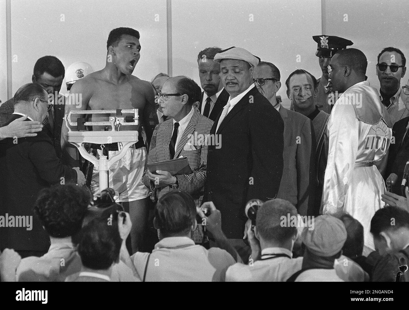 Muhammad Ali peels off his robe shouting he's the heavyweight champion ...