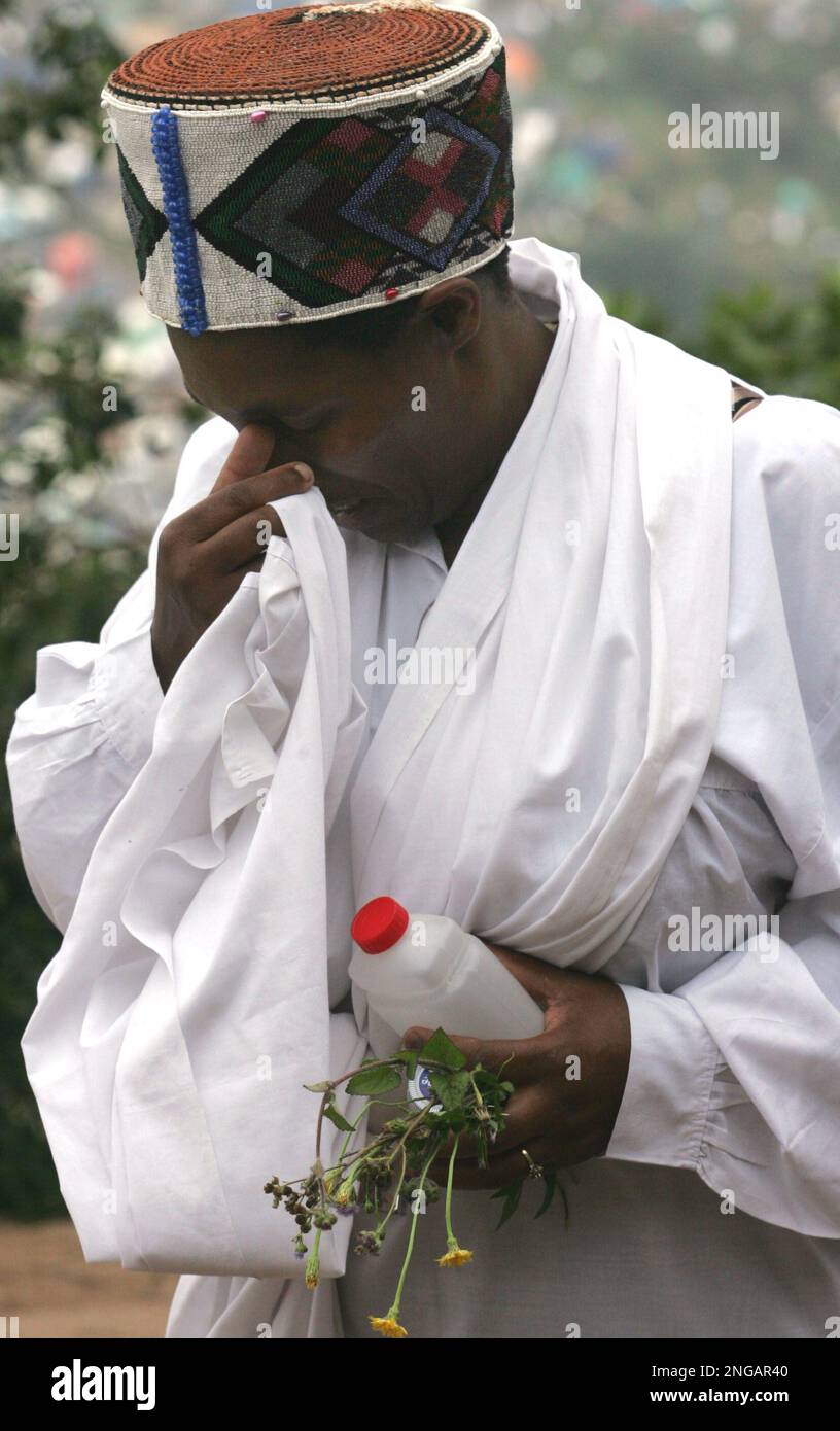 A member of the Nazareth Christian, (Shembe) Church prays as she ...