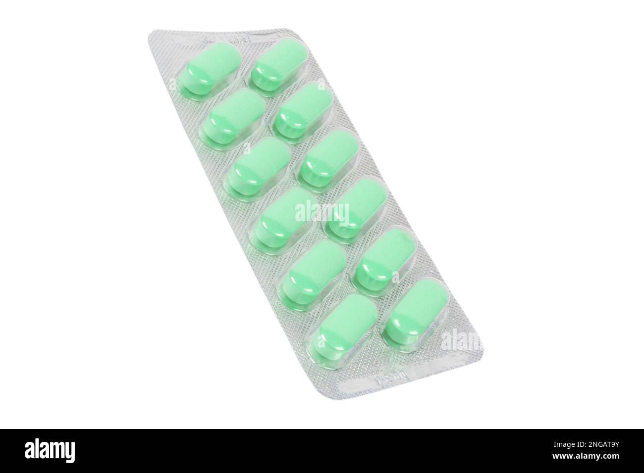 Macro shot pile of green tablets pill in blister packaging isolated on ...