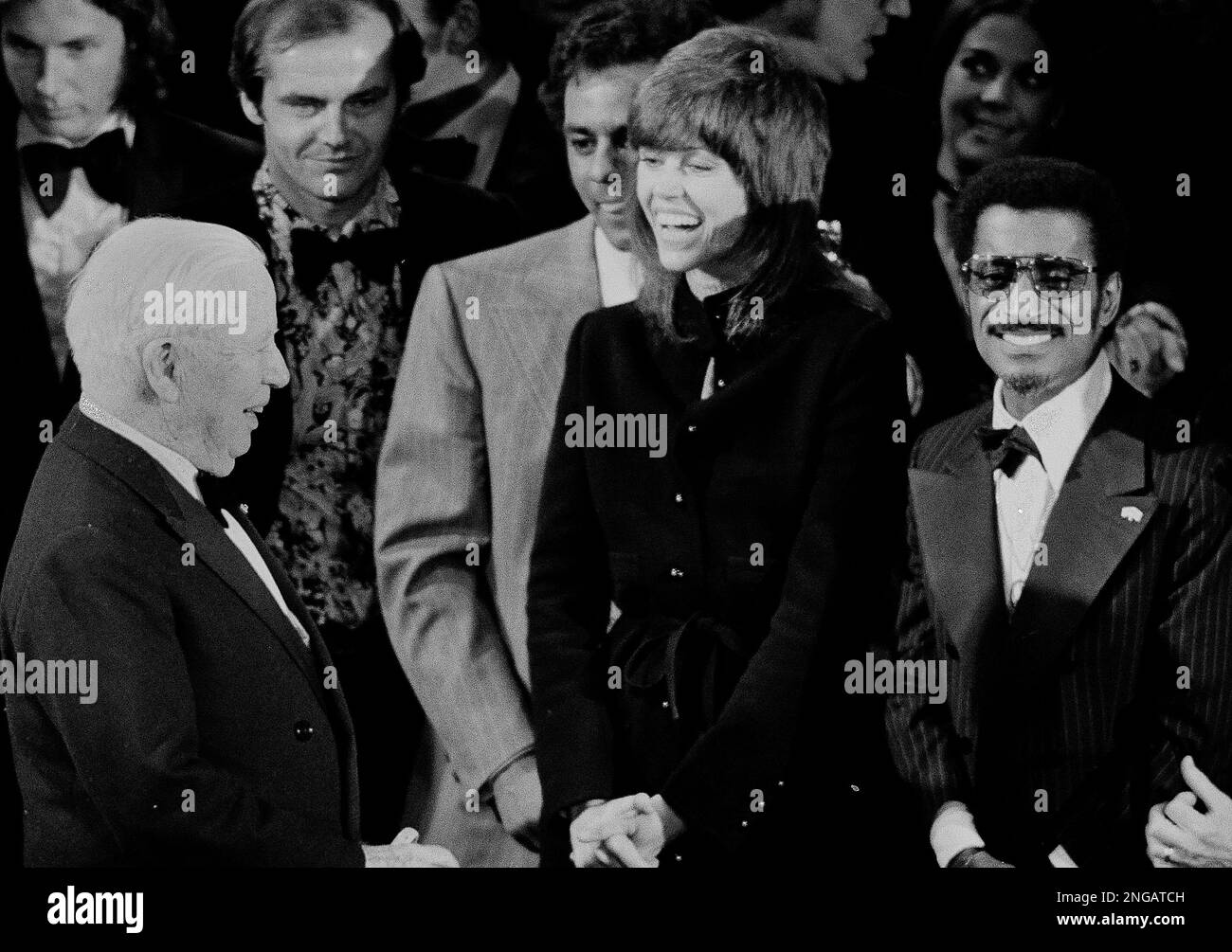Comedian/actor Charlie Chaplin talks with celebrities on stage at the ...