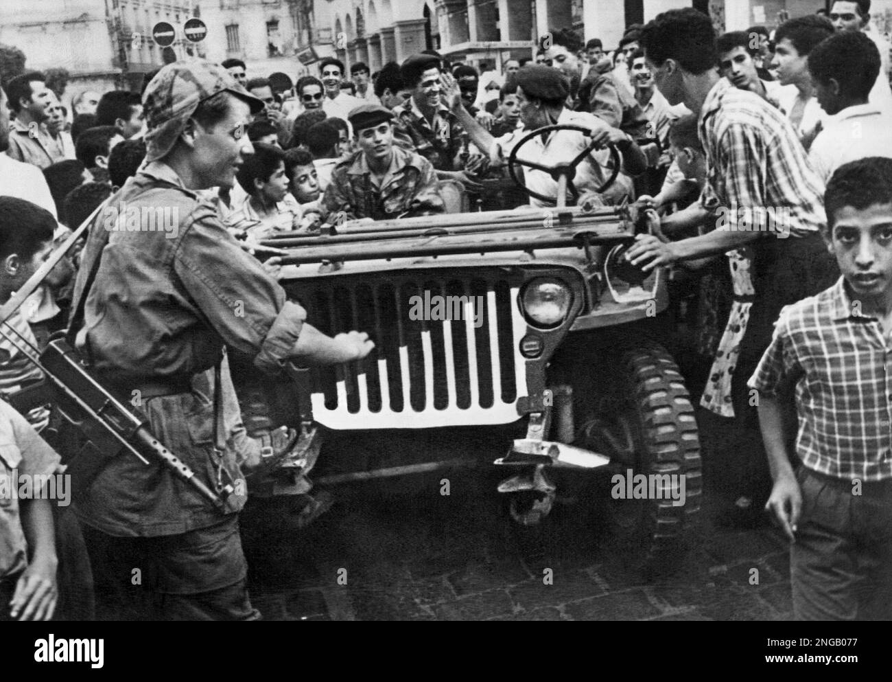 A jeep of the Algerian Liberation Front (FLN) is surrounded by an ...