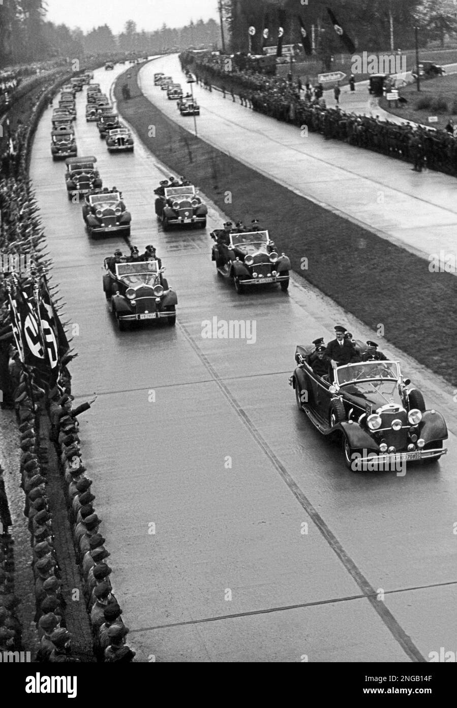 German chancellor Adolf Hitler, front, standing in first car ...