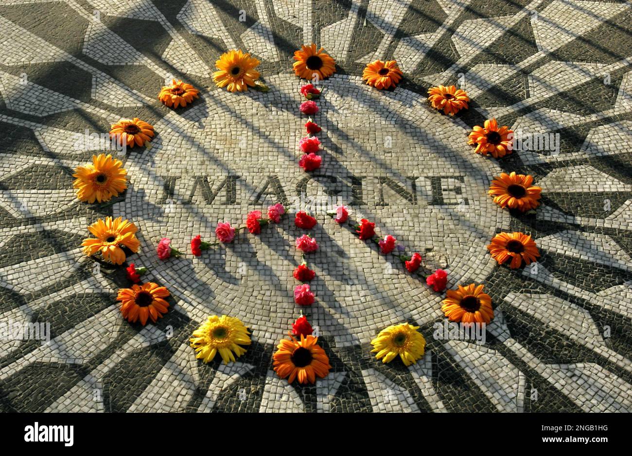 A makeshift peace sign of flowers lies on top John Lennon's "Strawberry ...