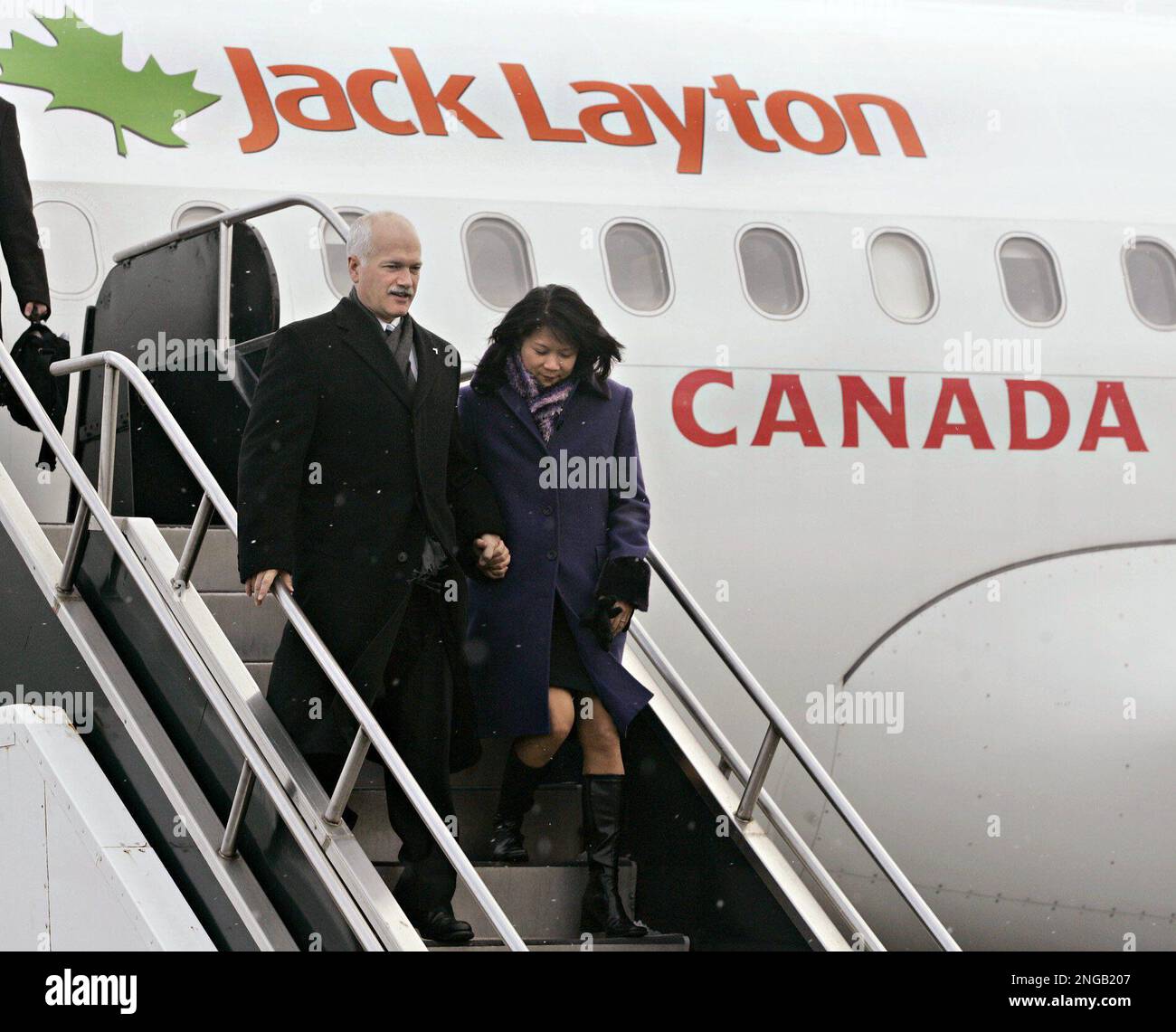 NDP Leader Jack Layton and his wife Olivia Chow make their way down the stairs of the campaign ...