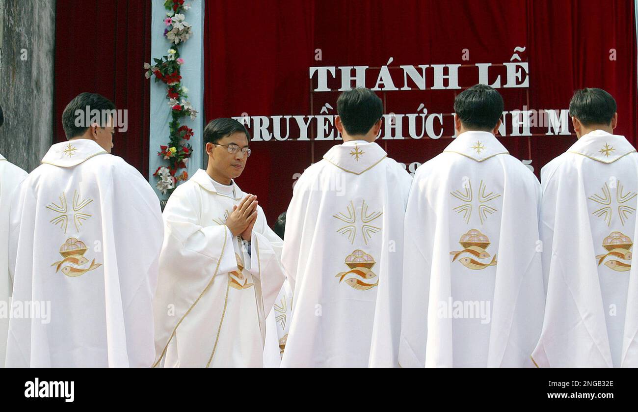 New Vietnamese Catholic priests walk across the stage during a historic ...