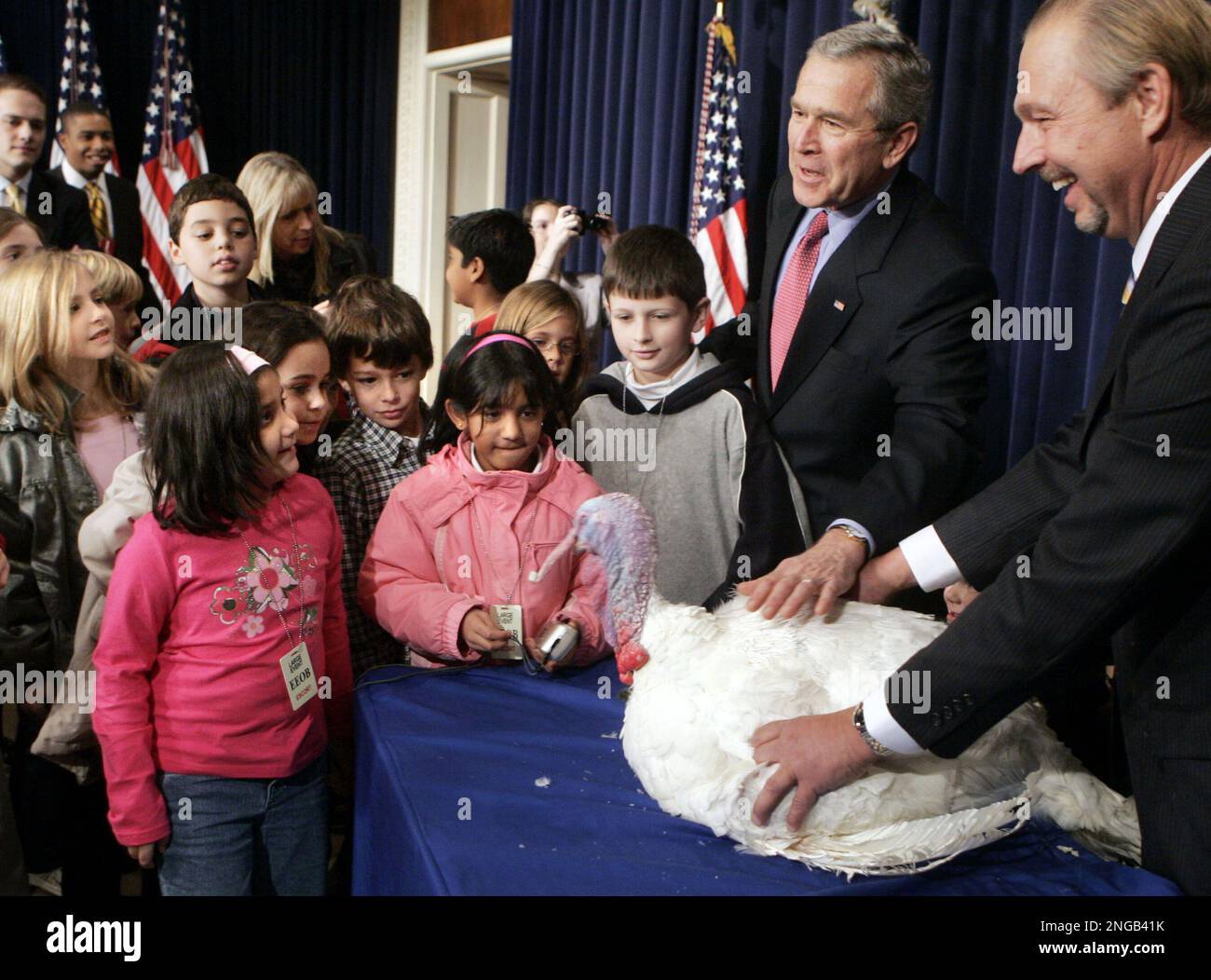President Bush pets the national Thanksgiving turkey Marshmallow during ...