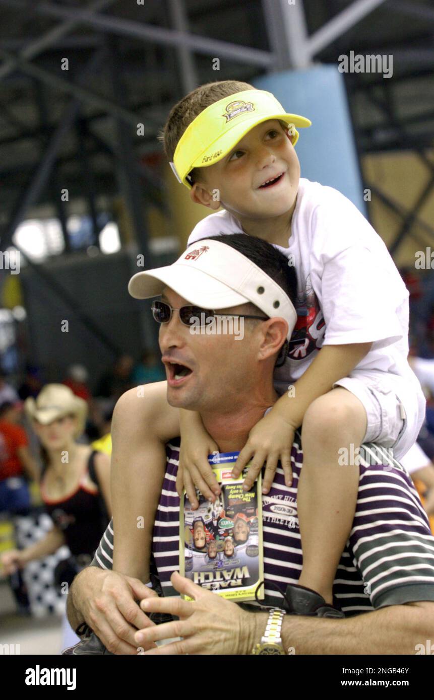 Jacob Fitts riding on the shoulders of Tom Vitale as they look around ...