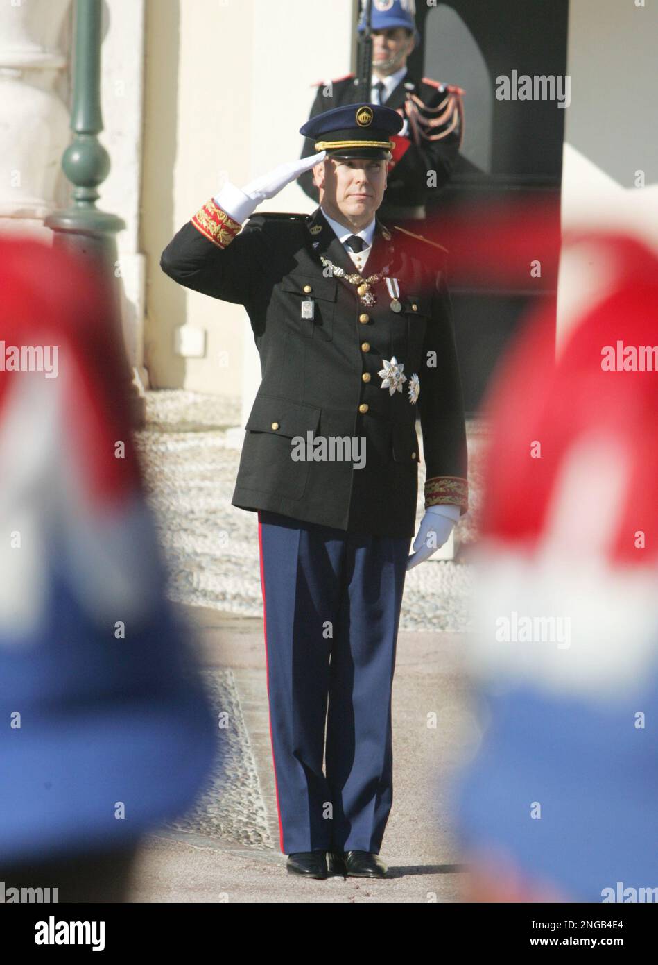 Prince Albert II of Monaco salutes guards outside the Monaco palace ...