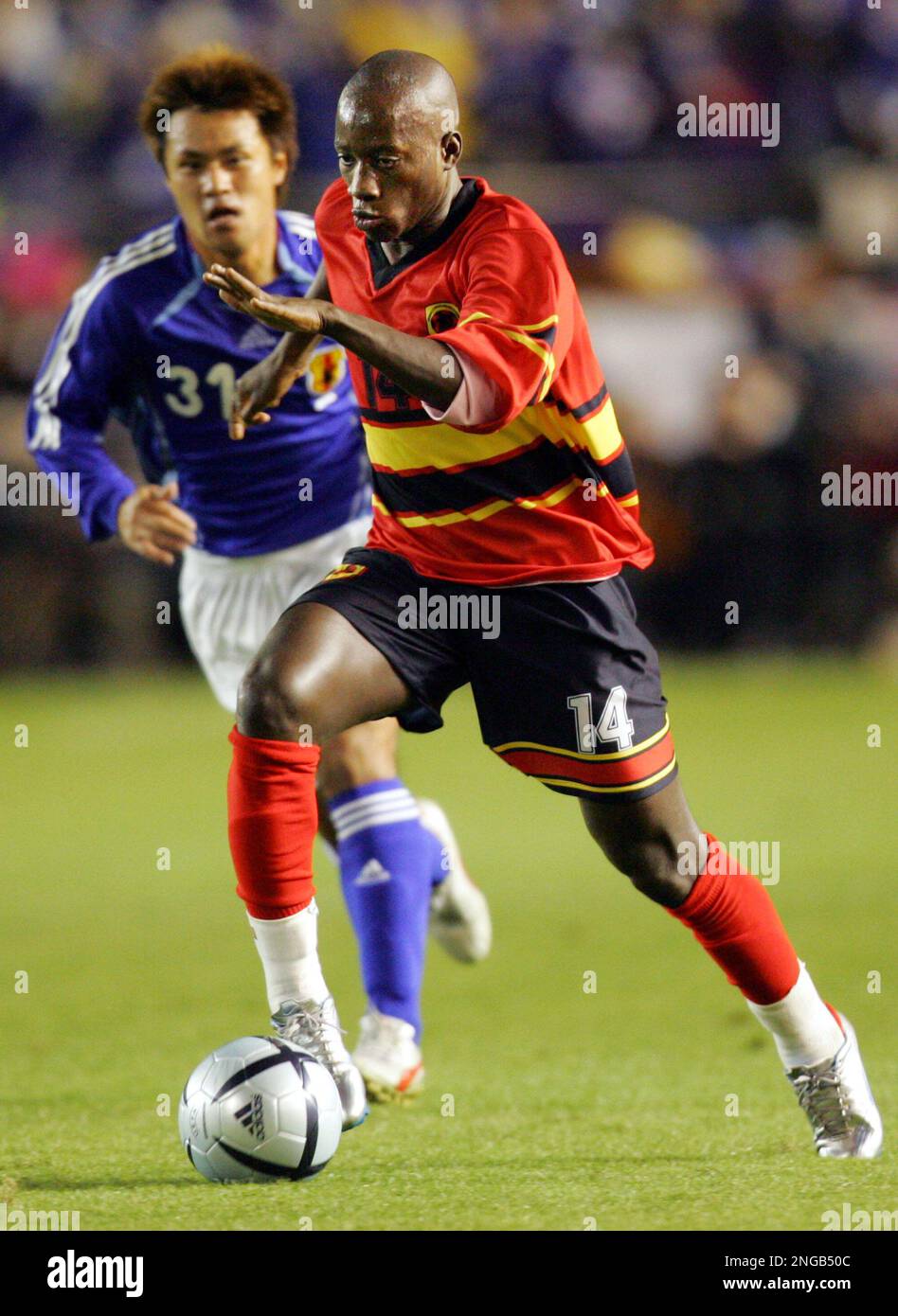 Mendonca of Angola national team, right, contols the ball as Japan's ...